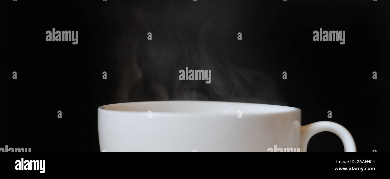 hot steam from the white cup with coffee drink on dark background Stock ...