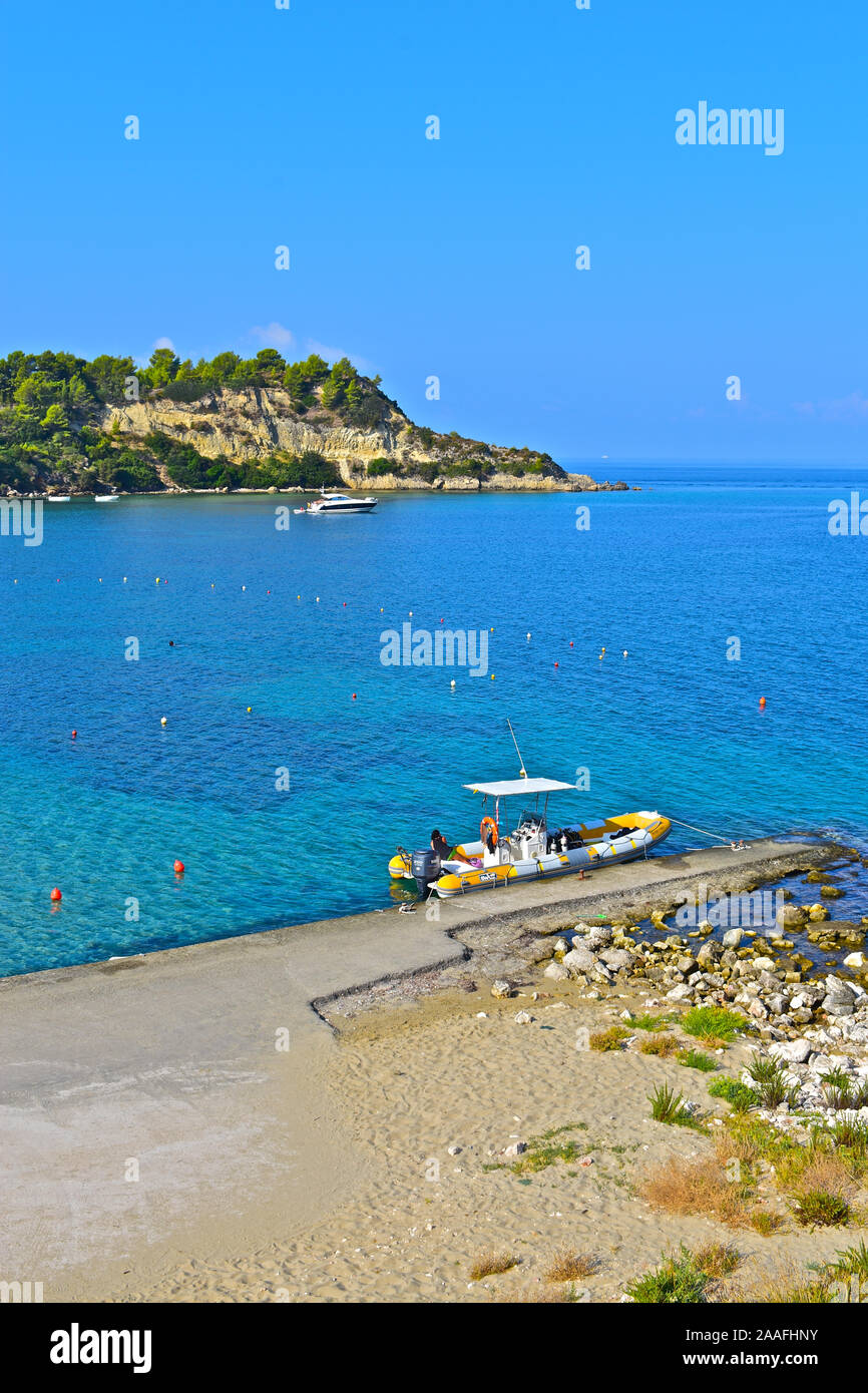 A rigid hull inflatable dive boat at the quay at a small beach in the ...
