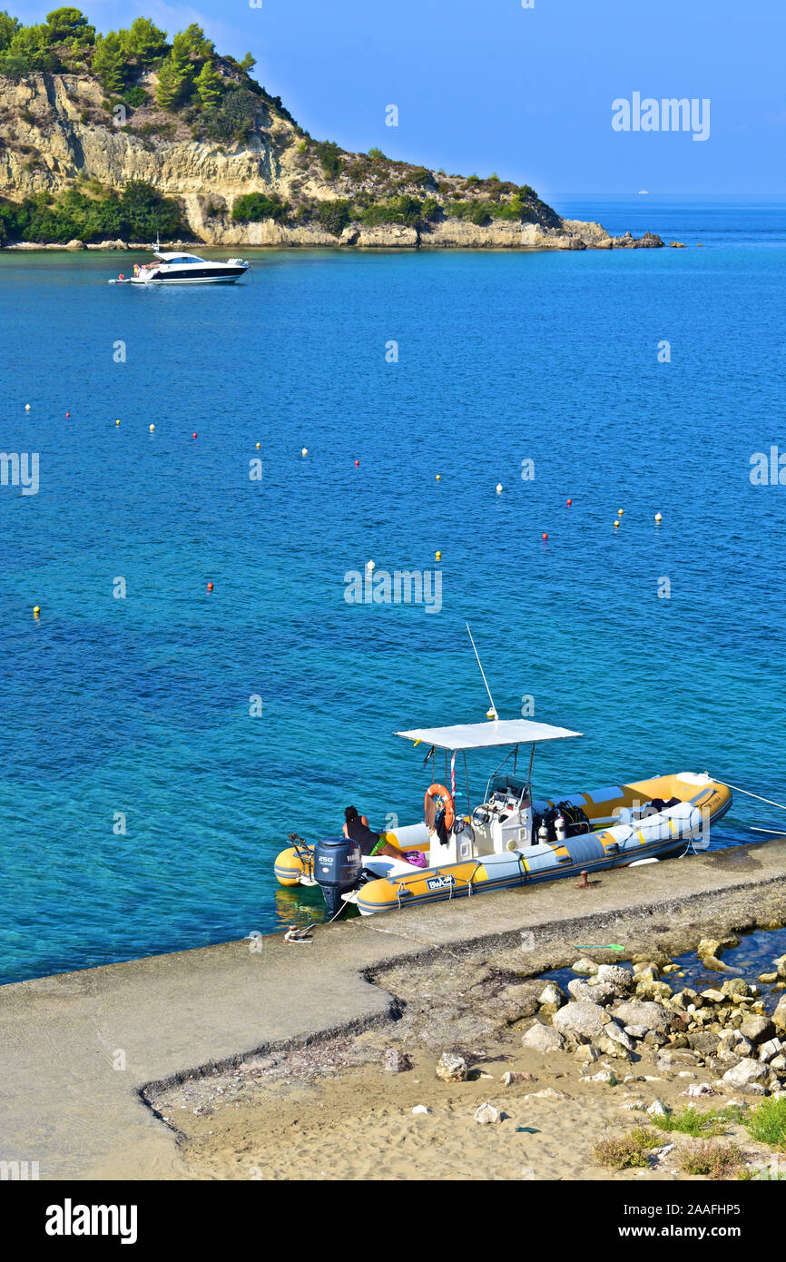 A rigid hull inflatable dive boat at the quay at a small beach in the ...