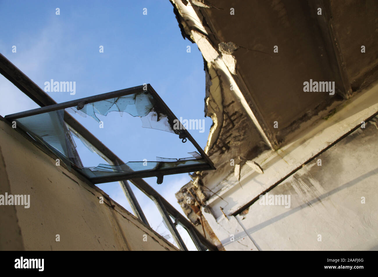 Broken window in the window frame. Old forgotten building. Contemporary ...
