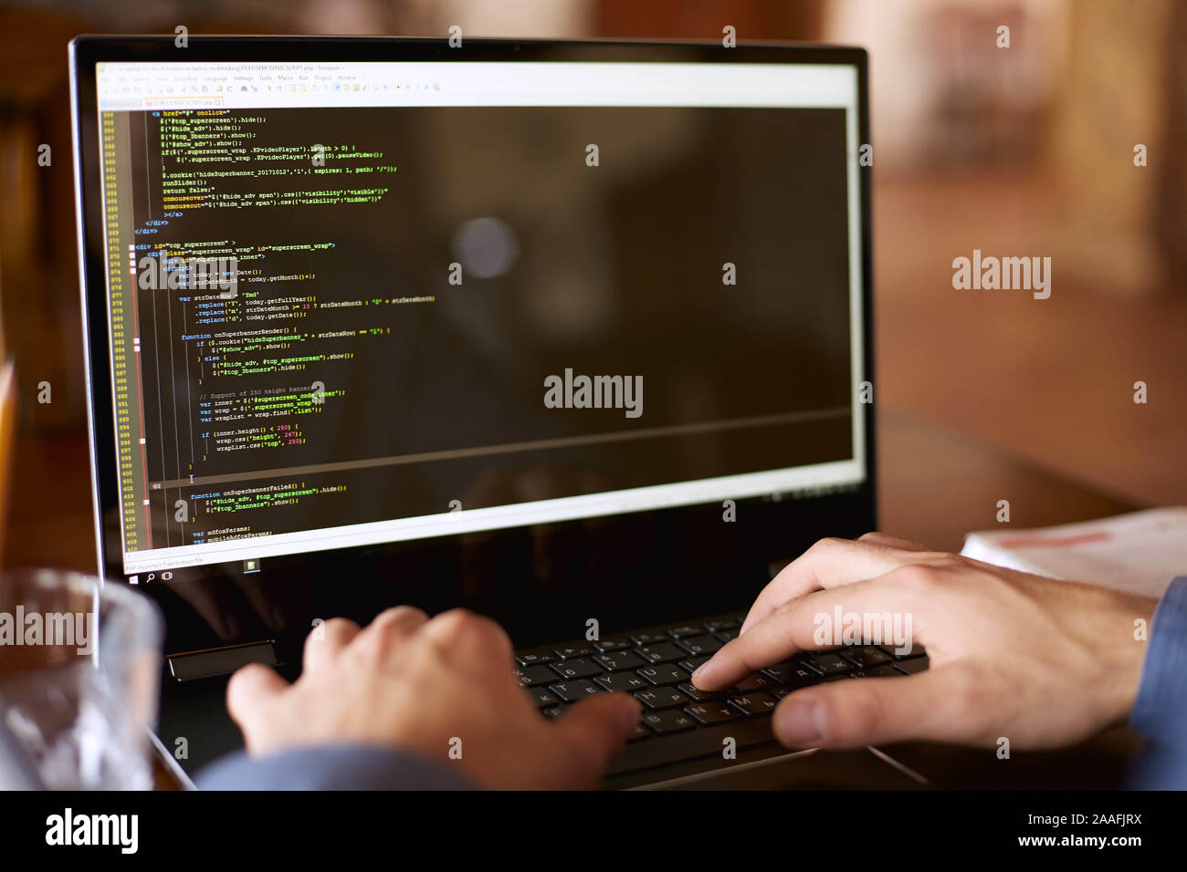 Back View Over The Shoulder Shot Of Developer Programmer With Laptop Program Code And Script