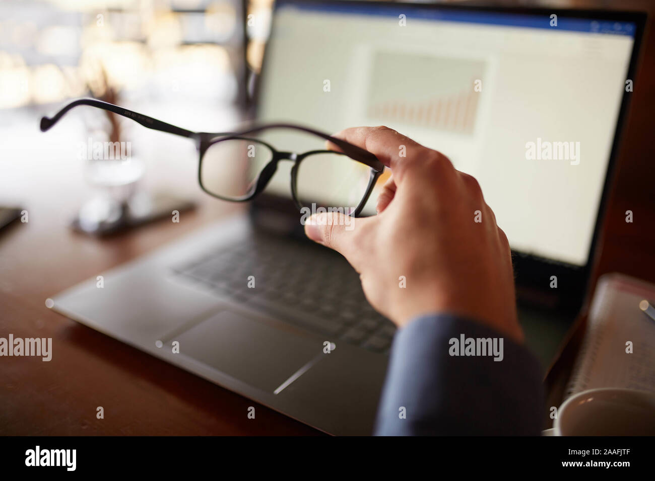 Close-up isolated shot of mans hand holding eyeglasses in front of ...