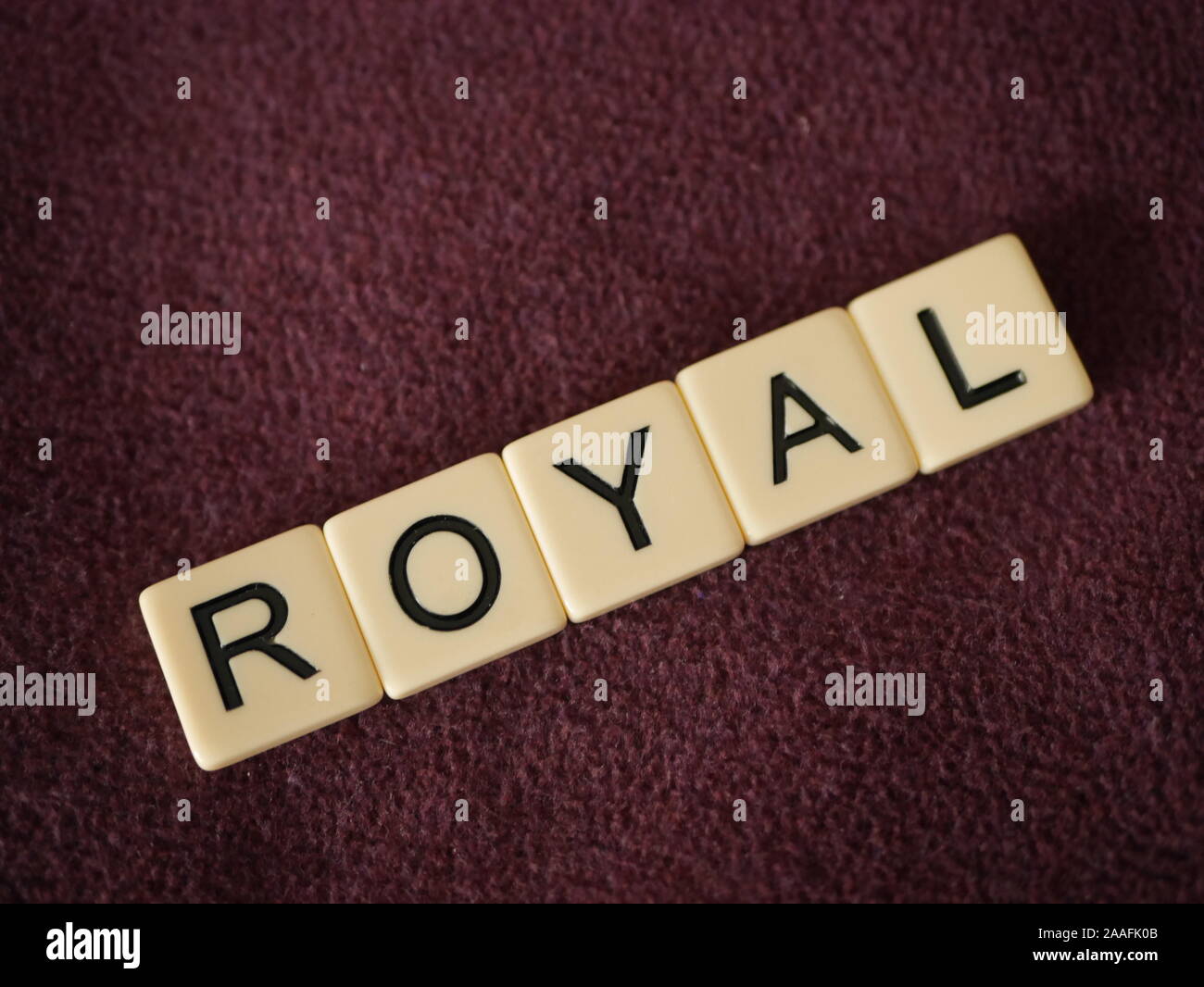 Word royal in black letters on white tiles with purple background Stock ...