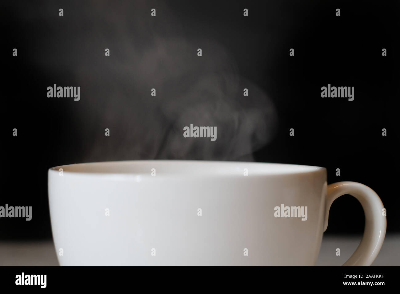 hot steam from the white cup with coffee drink on dark background Stock ...