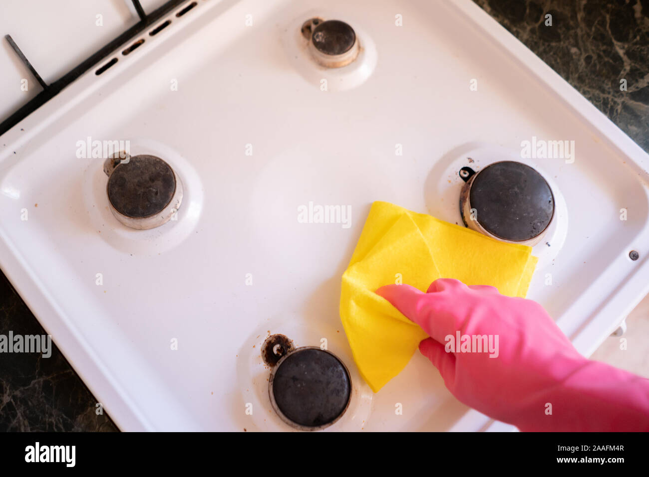 cleaning service washing the cooker stove at home s Stock Photo - Alamy