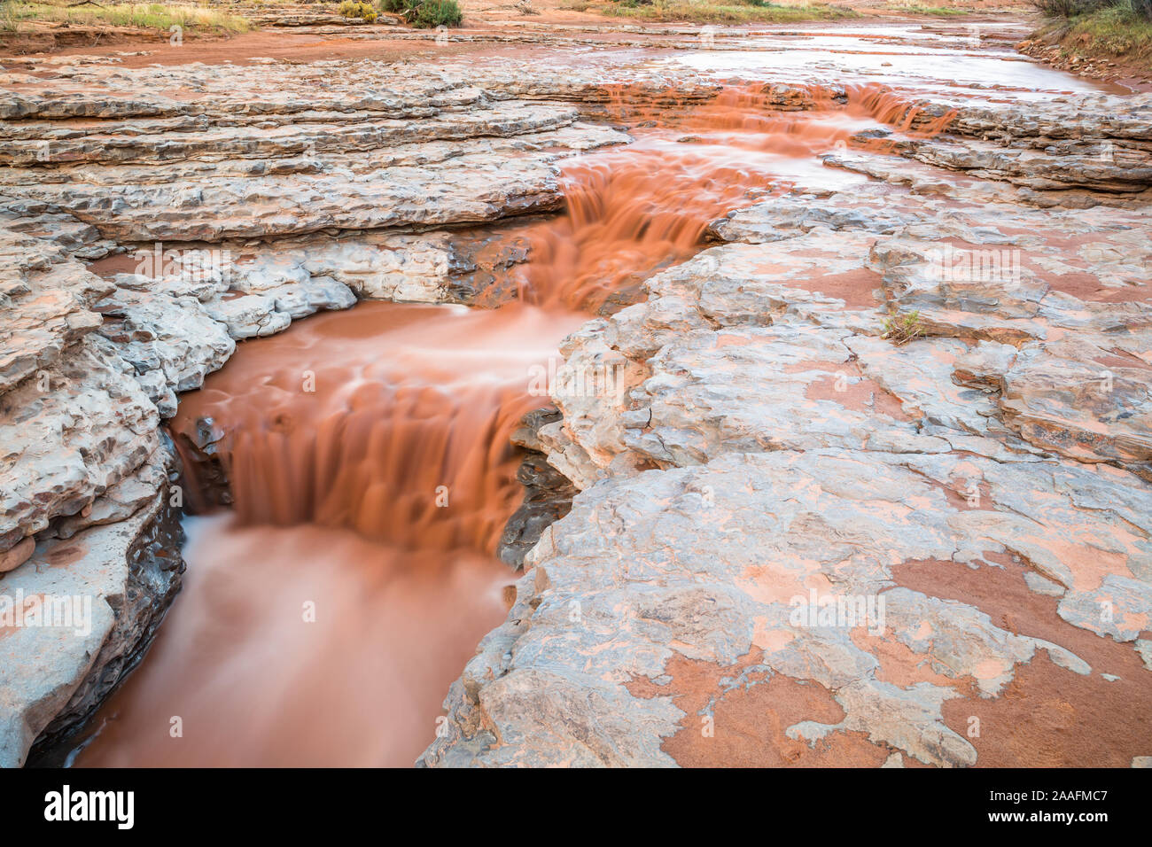 Flooded valley in rising flash flood after a summer rainstorm near Moab ...