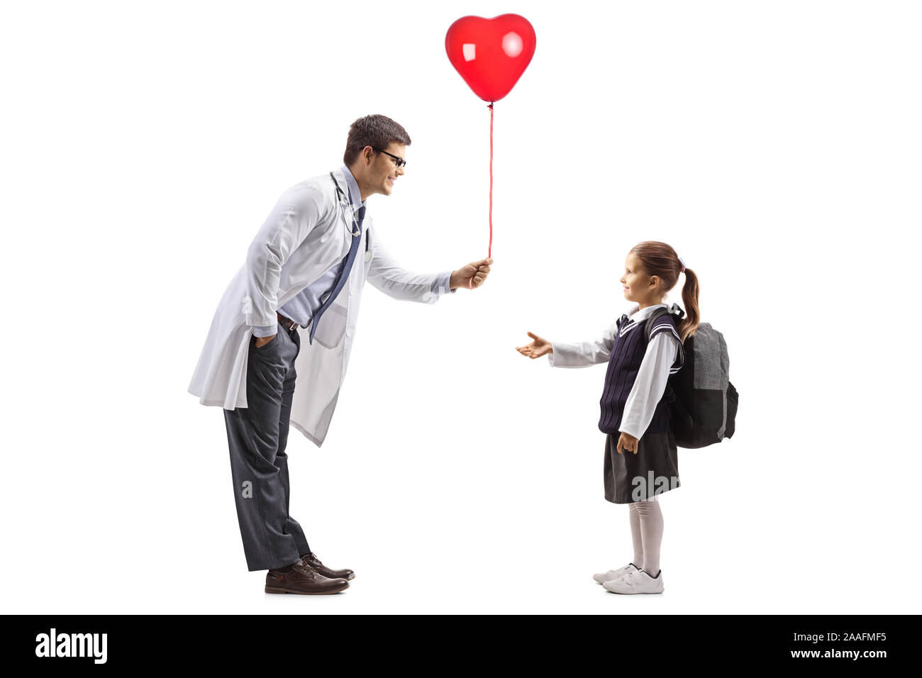 Full length shot of a male doctor giving a heart shaped balloon to a ...
