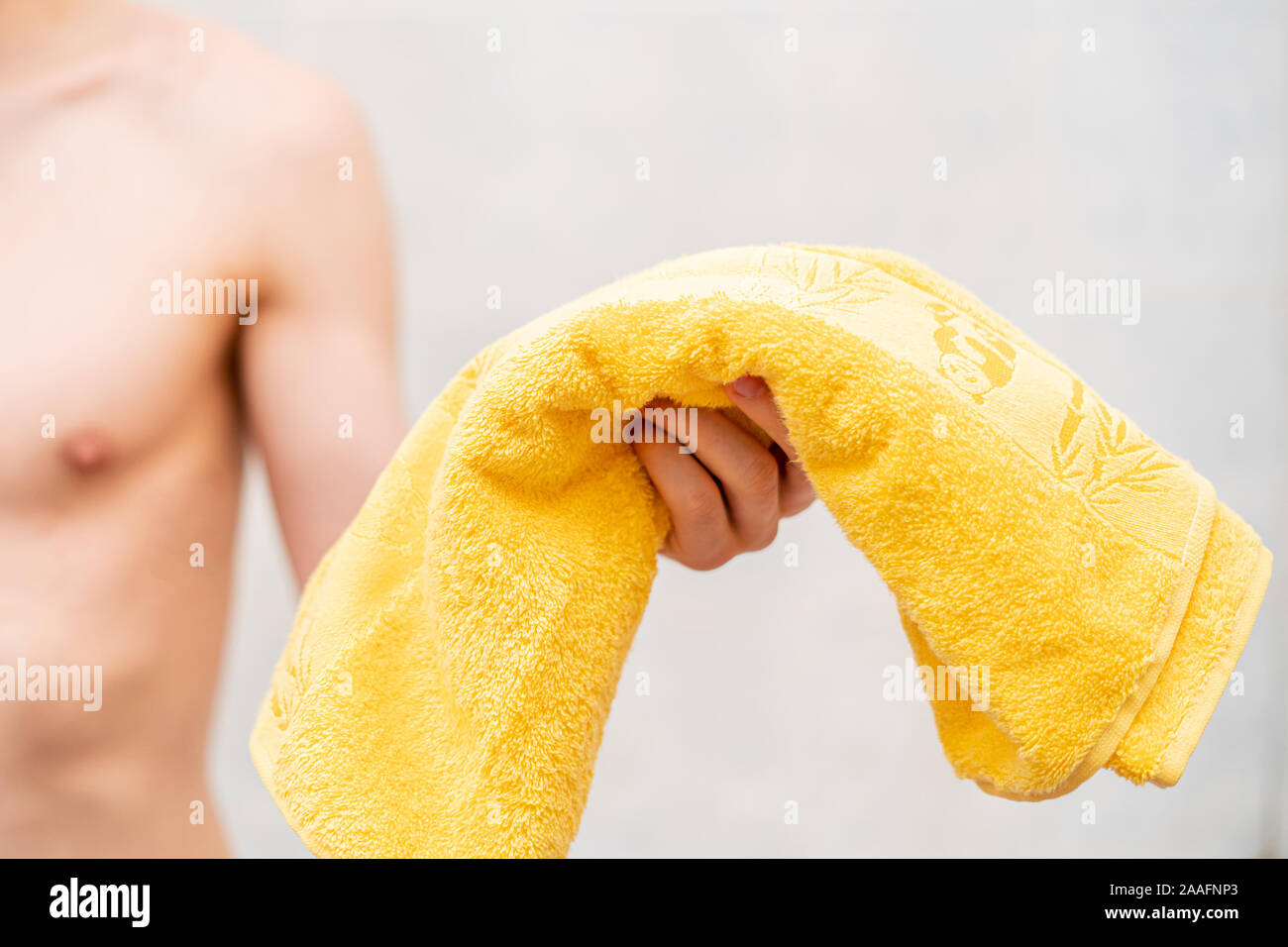 person hand holding a color towel before taking a bath Stock Photo - Alamy