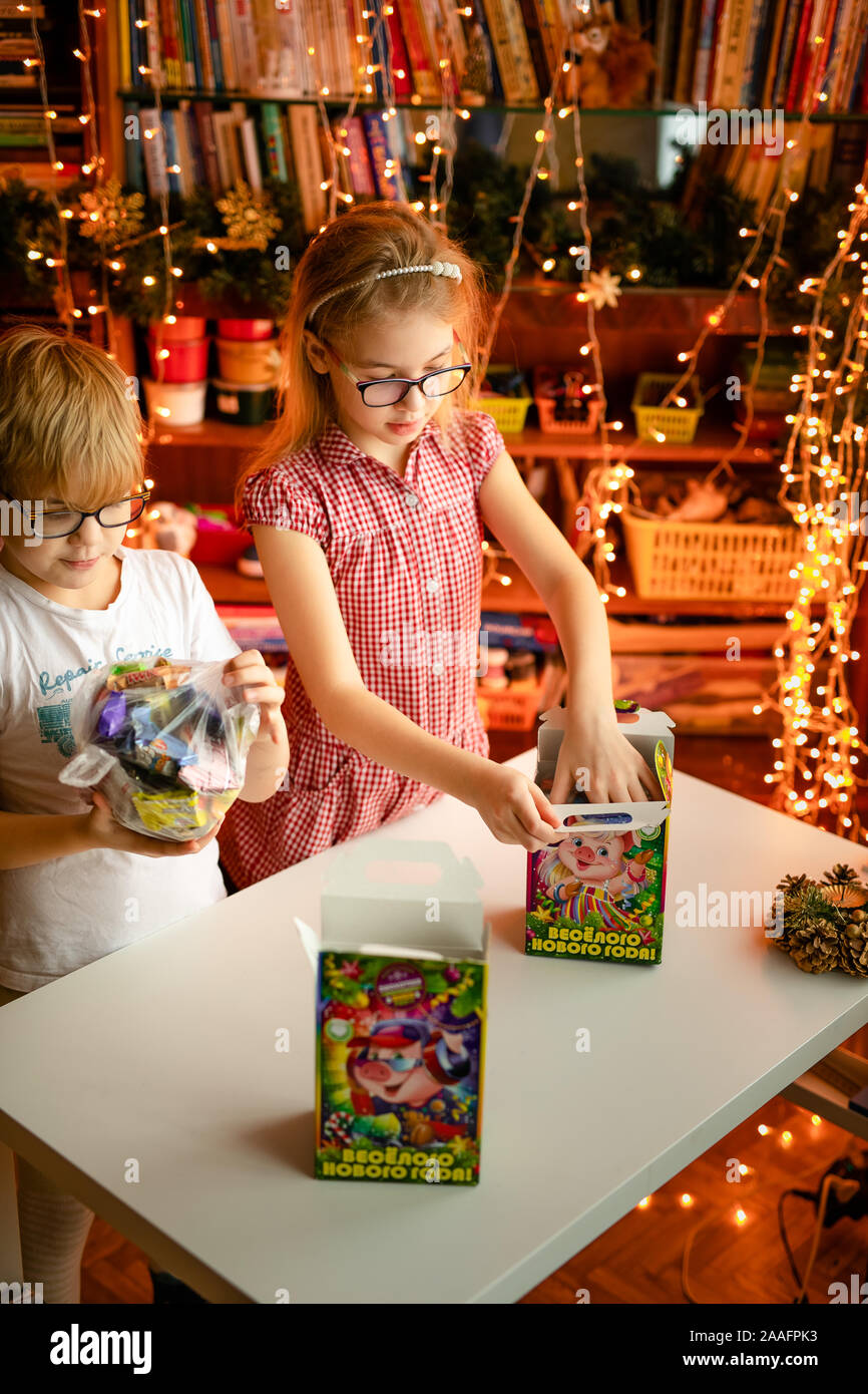 Children opening Christmas presents. Little girl and boy with present ...