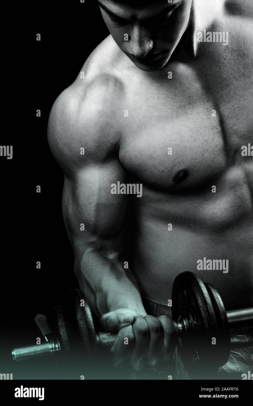 Muscular male bodybuilder doing biceps curl with dumbbell over dark ...