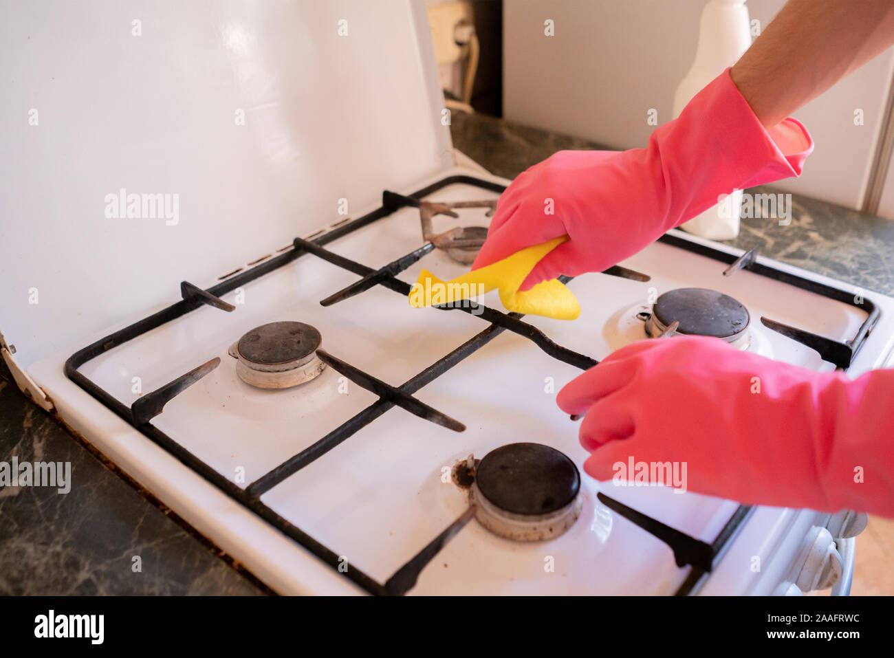 cleaning service washing the cooker stove at home s Stock Photo - Alamy