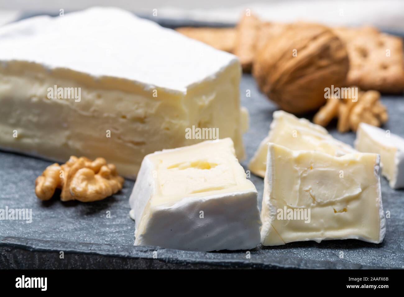 Cheese collection, piece of French brie cheese with white mold close up ...