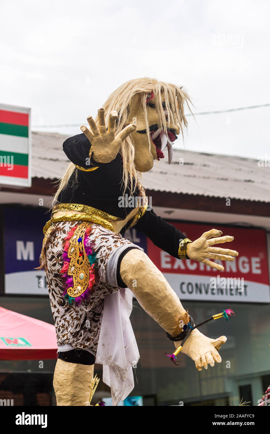 Parade on the street of the island of Bali. A huge stuffed demon for a ...