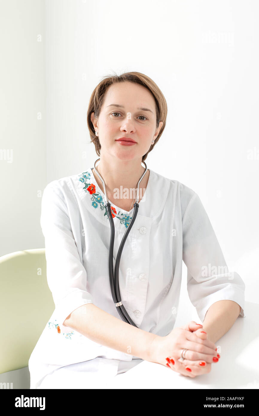 portrait of a young woman professional doctor with short haircut, in a ...