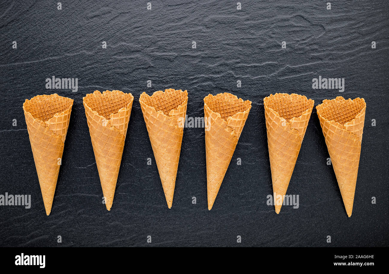 Flat lay ice cream cones collection on dark stone background . Blank ...