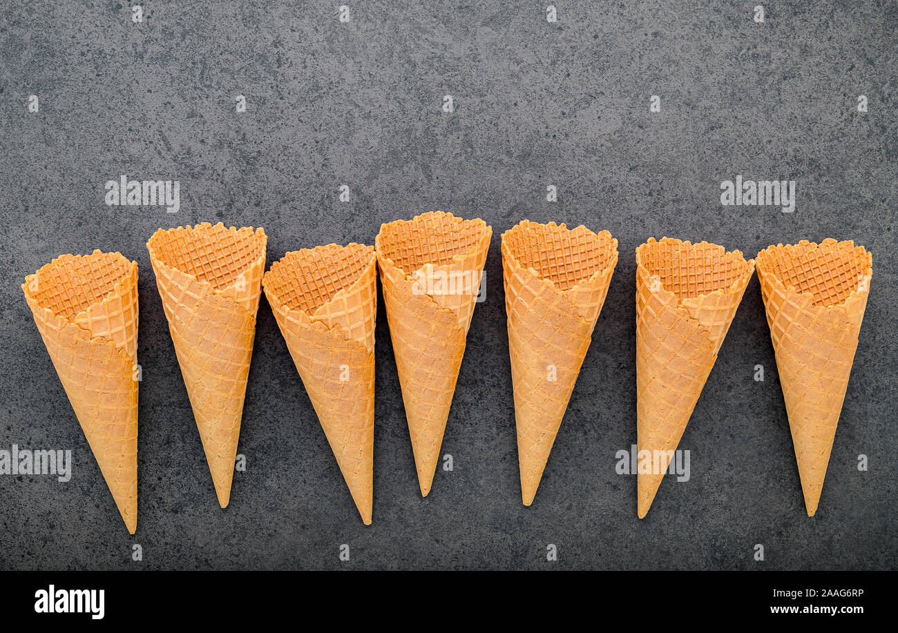 Flat lay ice cream cones collection on dark stone background . Blank ...