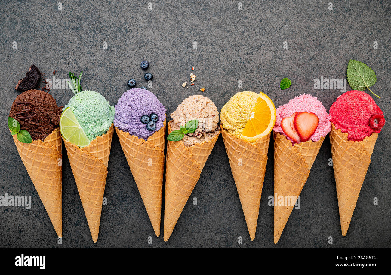 Flat lay ice cream cones collection on dark stone background . Blank ...