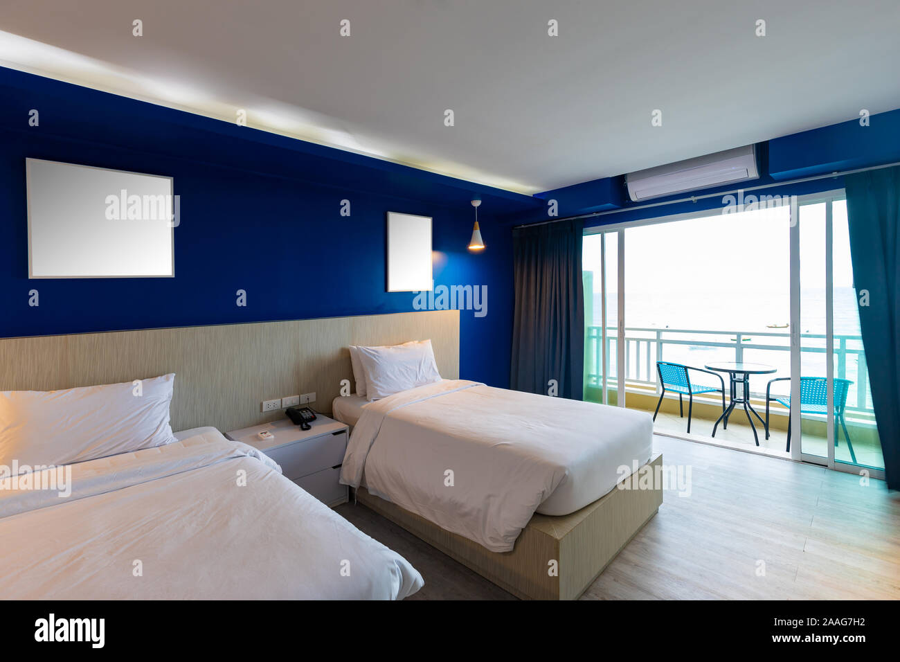 Dark blue tone interior of hotel room with wooden floor with sea view ...