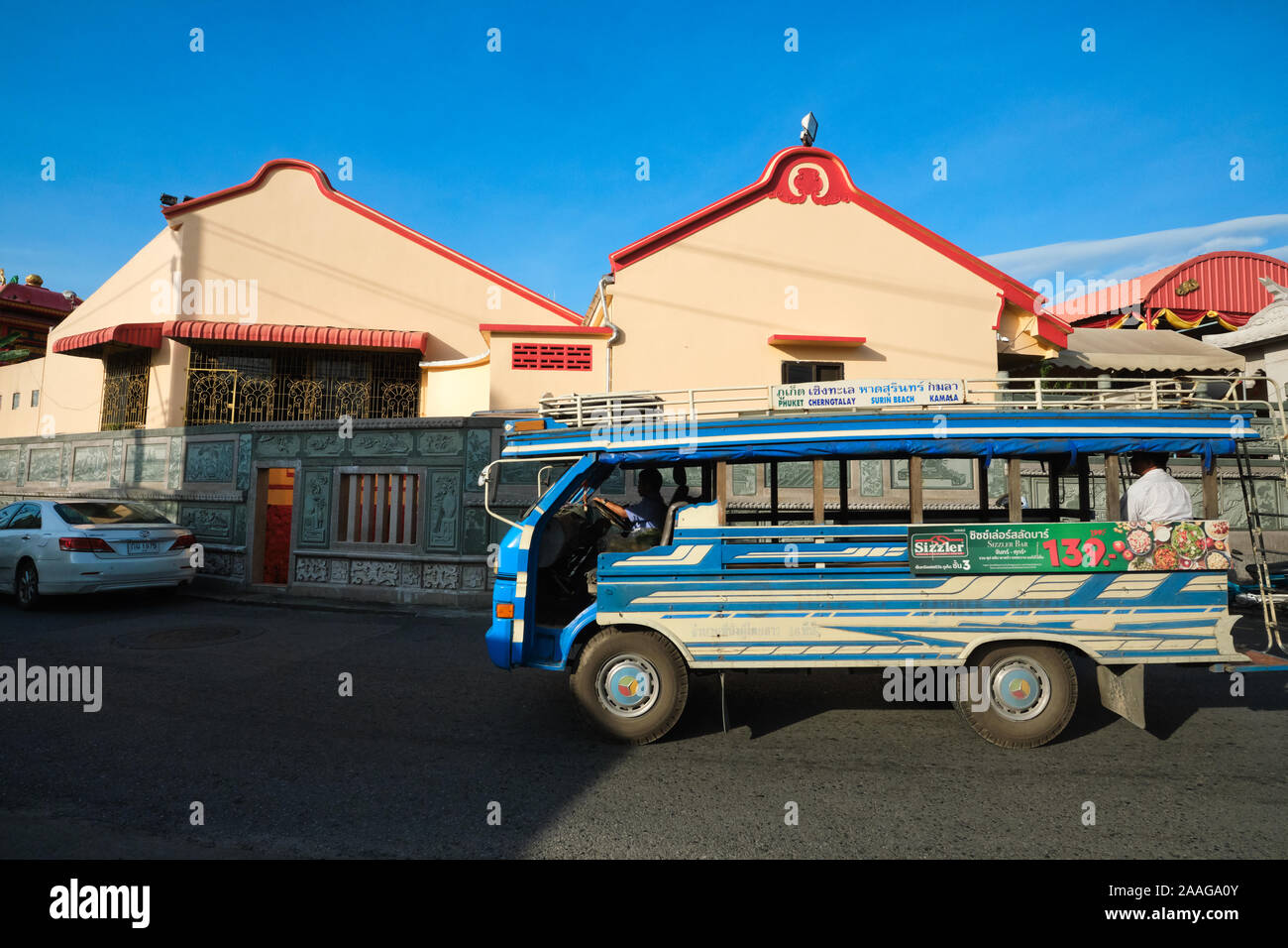 A local 'Songthaew' bus passes in front of Put Cho (Pud Jor) Temple in ...