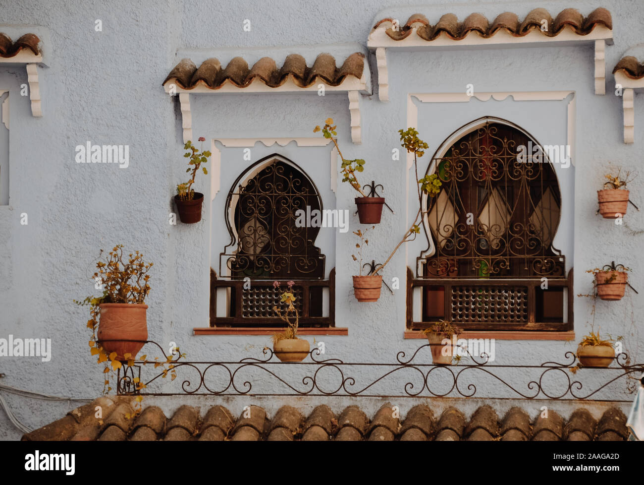 Two arabic windows with plant pots Stock Photo - Alamy