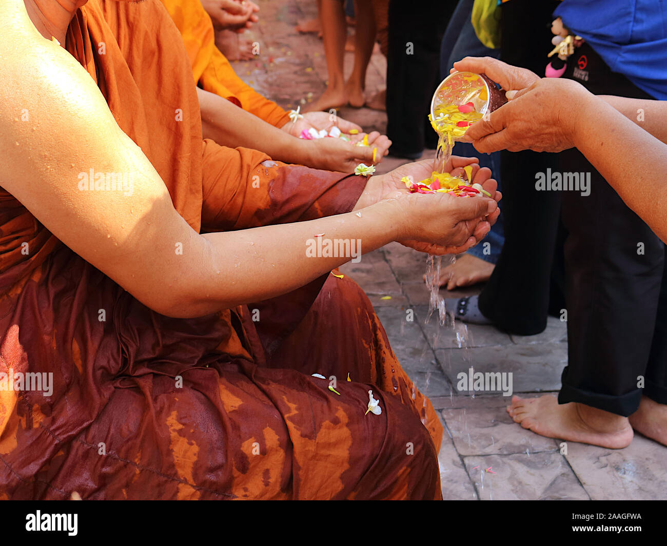 During the Songkran festival, people participate in a water pouring ...