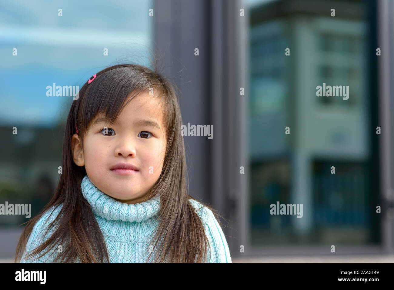 Fun happy pretty little girl grinning at the camera as she poses ...