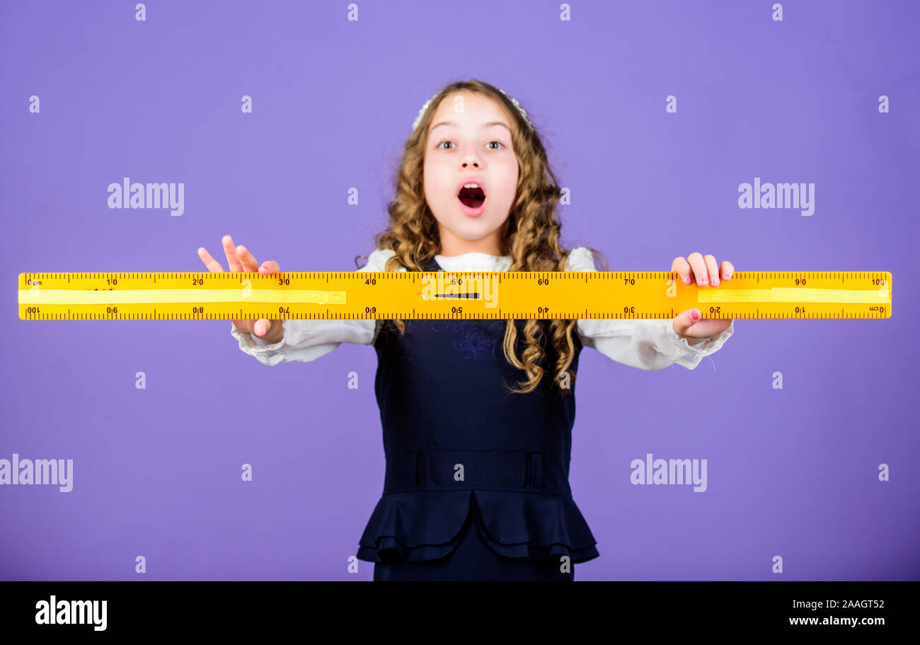 Pupil cute girl with big ruler. Geometry school subject. Education and ...