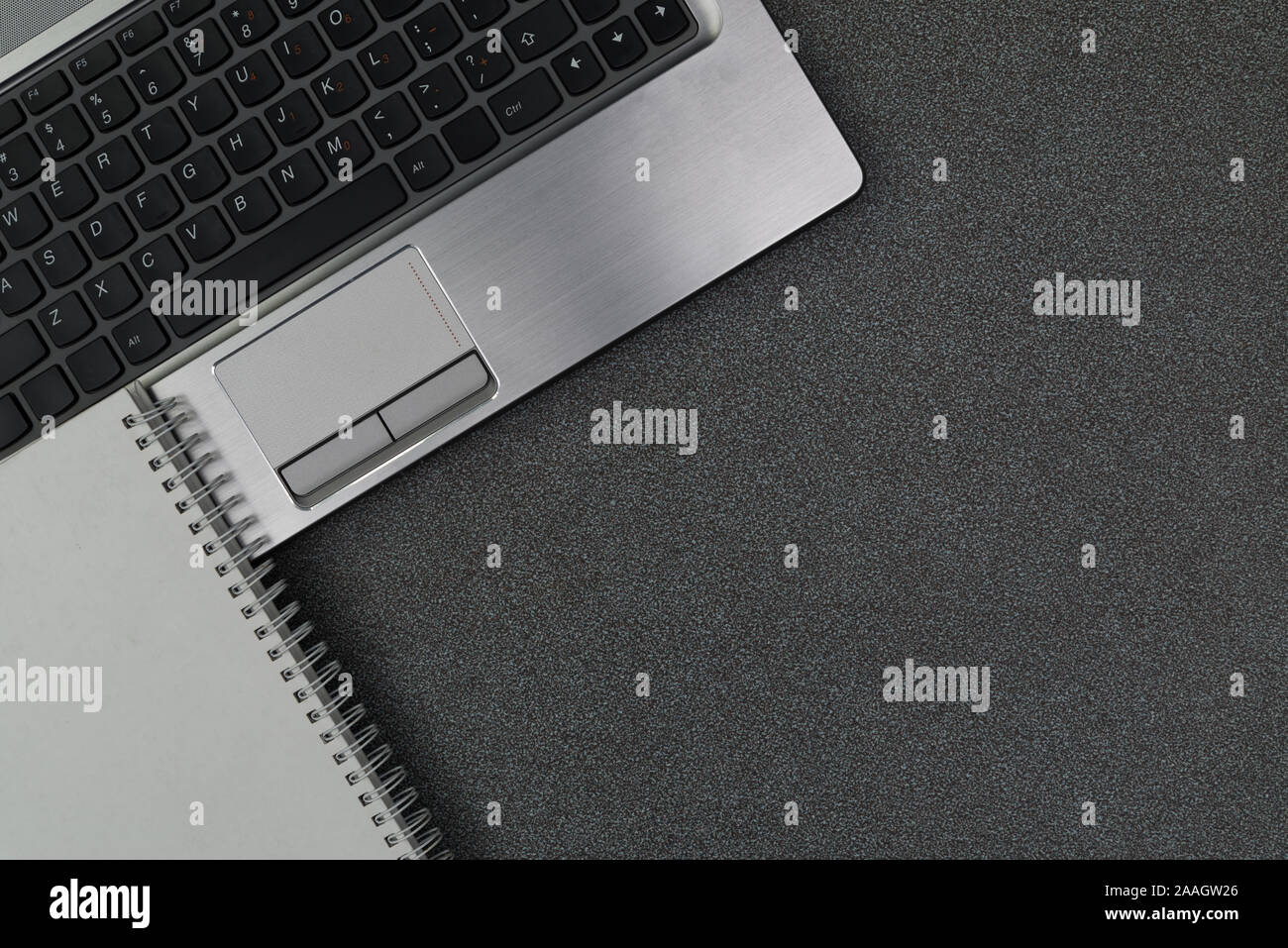 Laptop computer or notebook and note on gray color modern working table ...