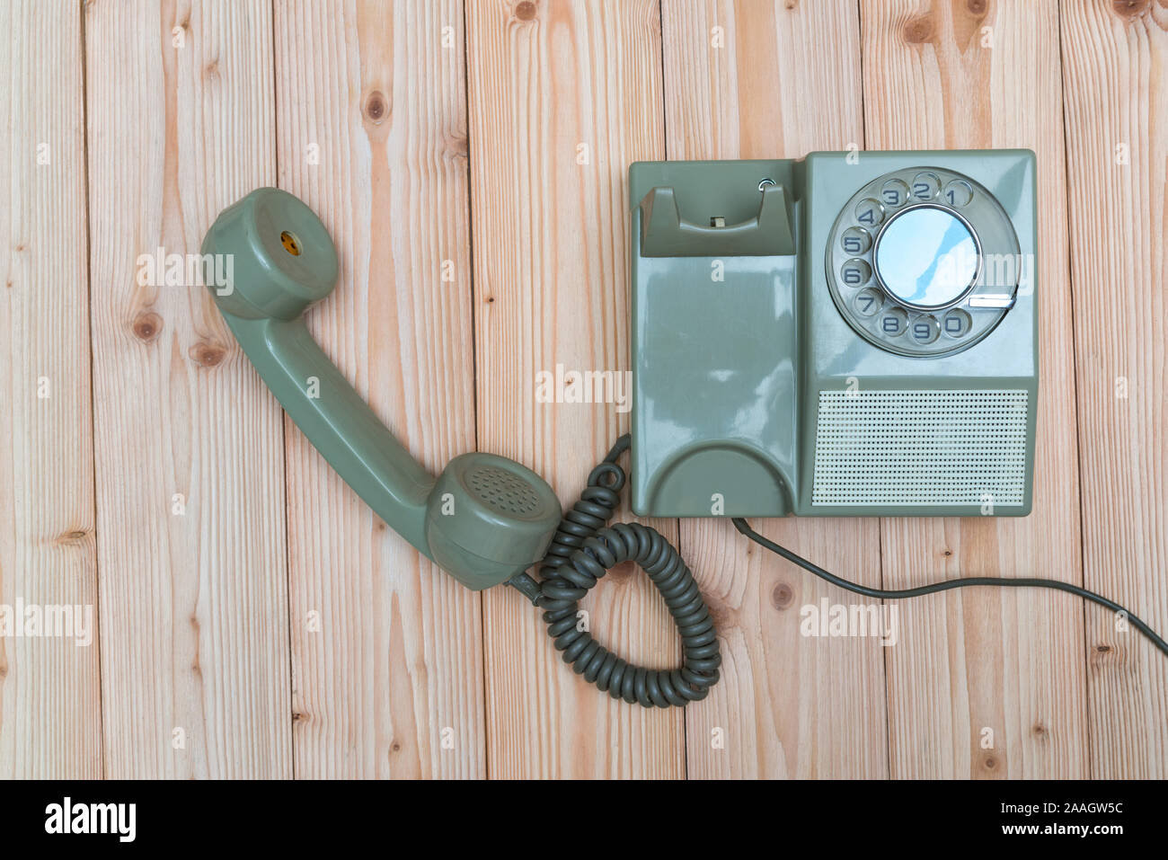 Retro rotary telephone or vintage phone with cable on wood table ...