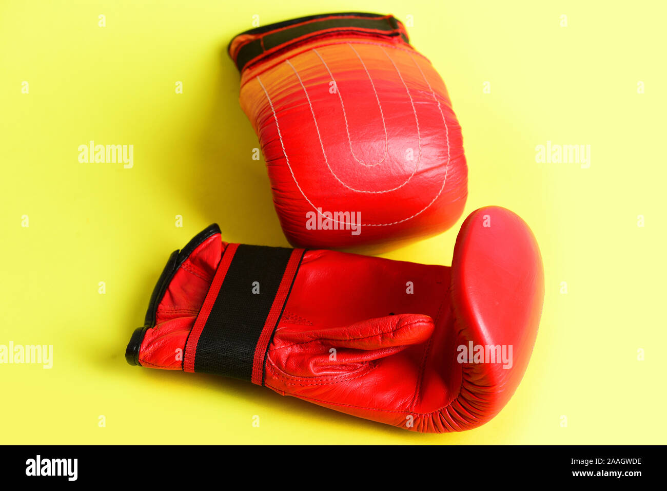 Mittens for boxing in red color isolated on deep yellow background ...