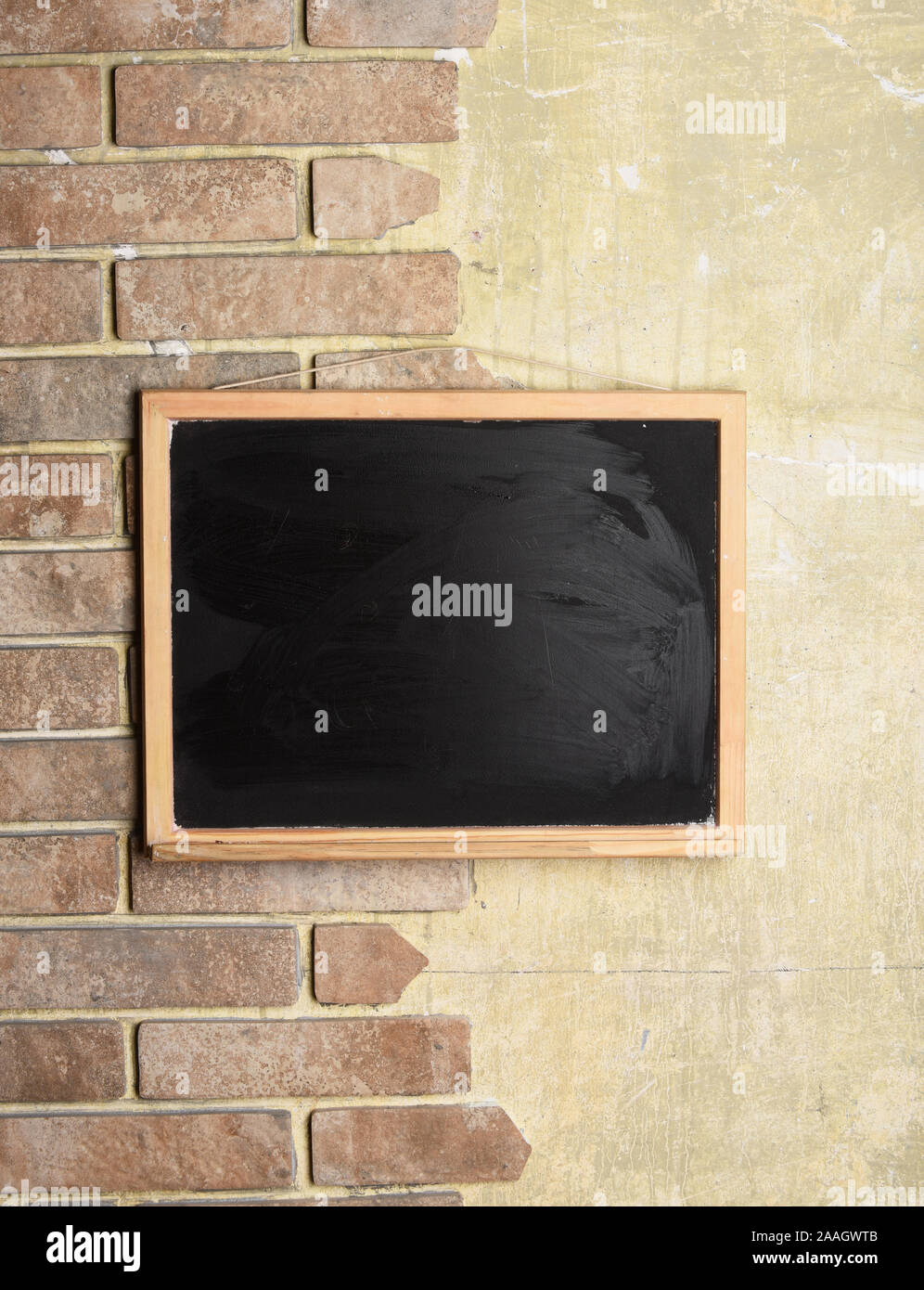 textured pastel and brick wall background and blackboard in wooden ...