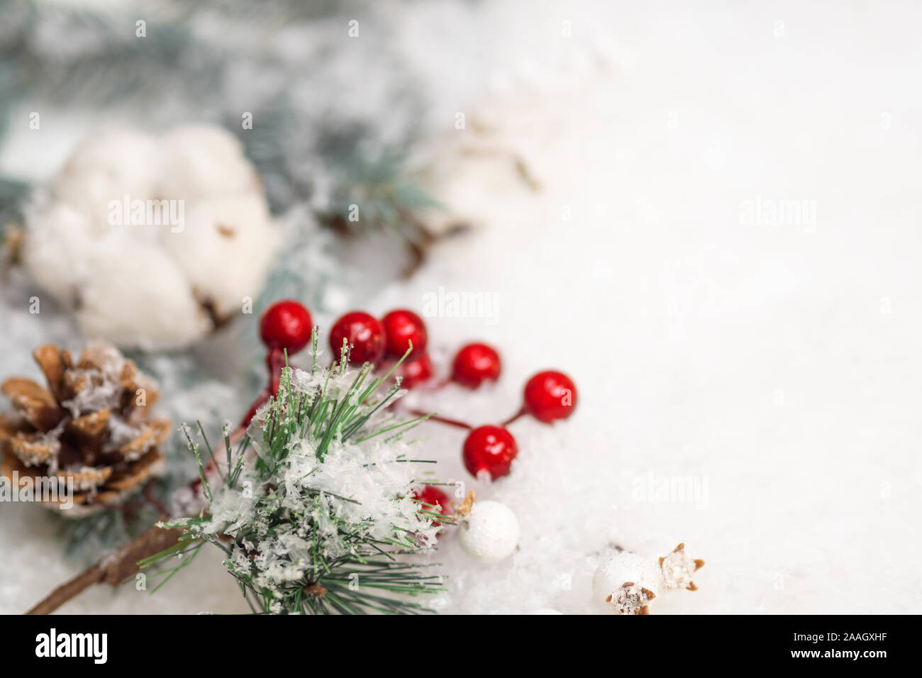 Festive winter flat lay. Snow, cones and branches of a green Christmas ...