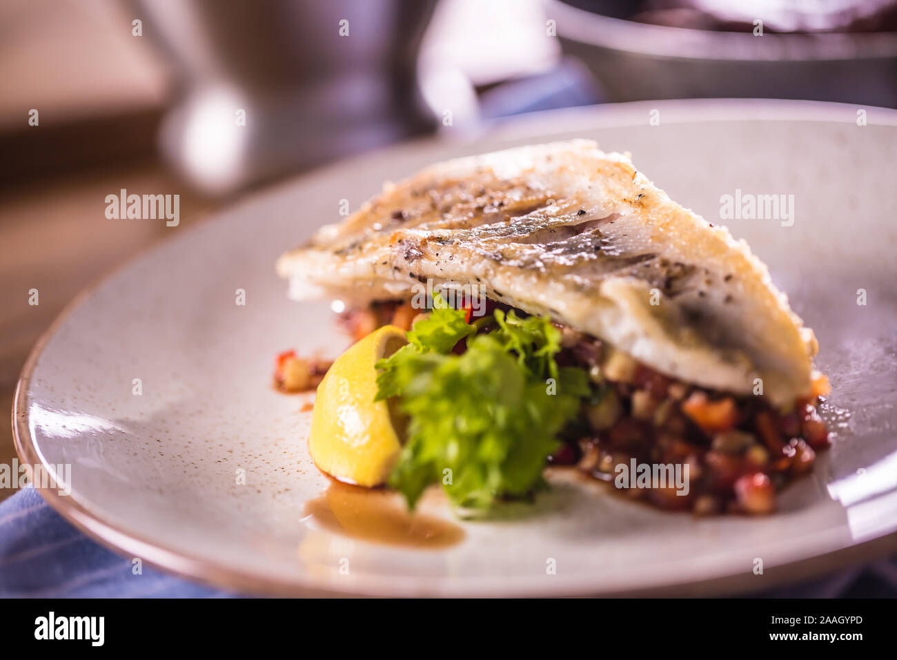 Fillet of zander with vegetables on a plate in a restaurant Stock Photo ...