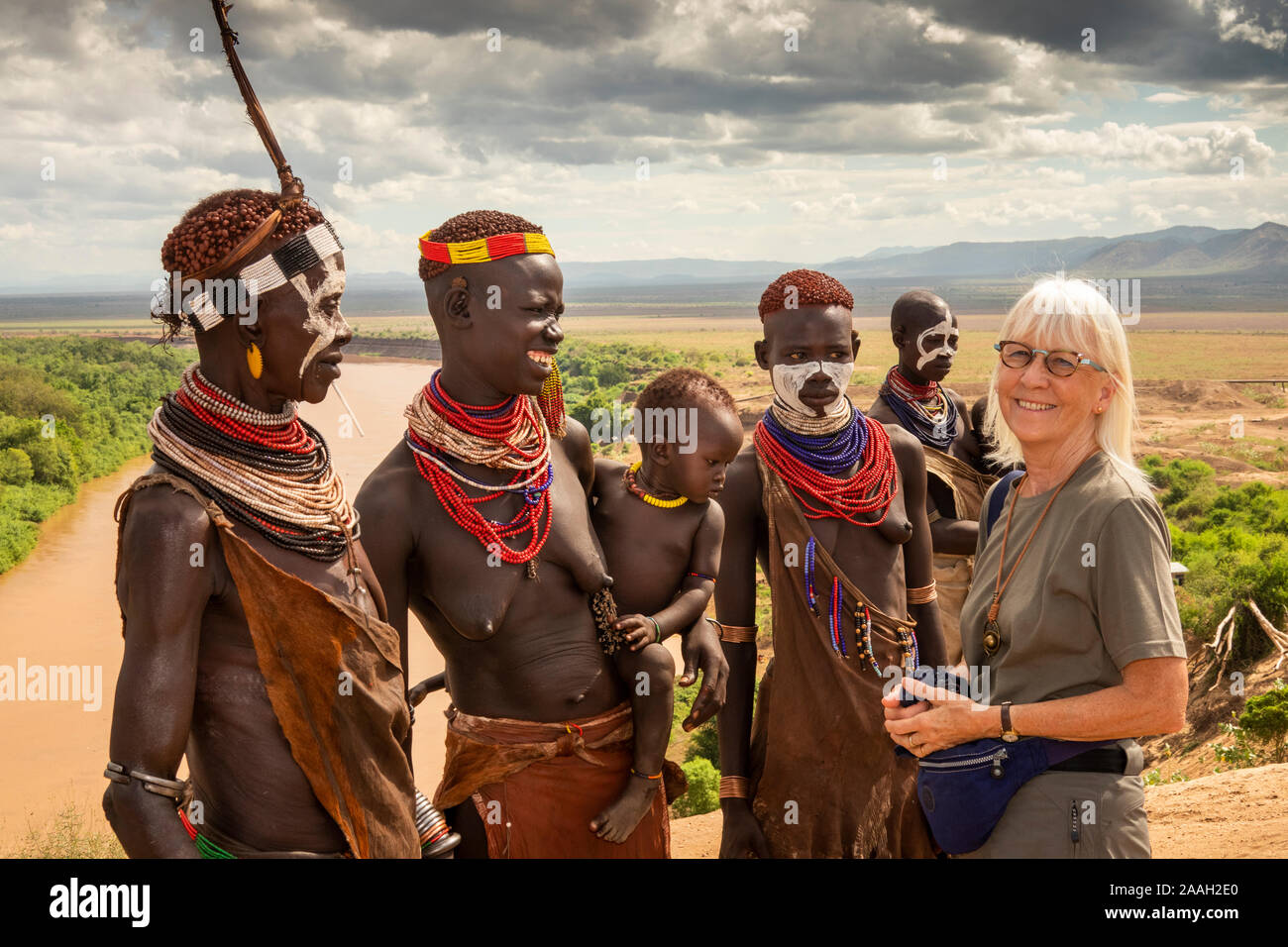 Ethiopia, South Omo, Kolcho village, senior western tourist amongst ...