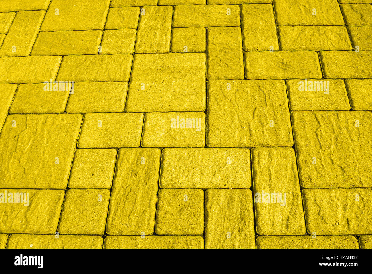 Geometric bright yellow background with artificial stone paving made of ...