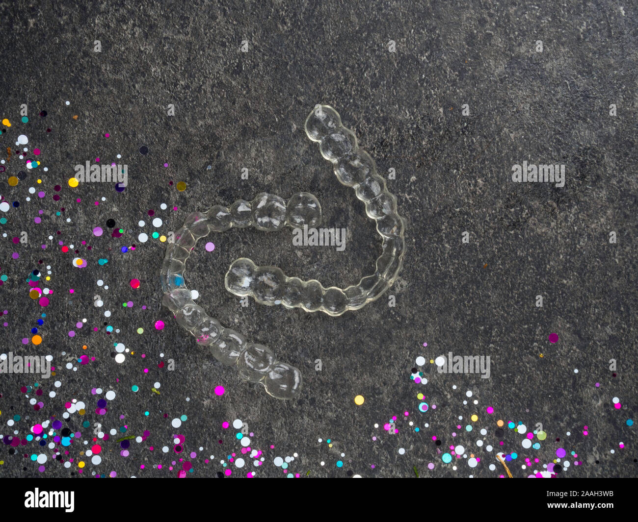 Corrector position invisible teeth over gray background, with festive ...