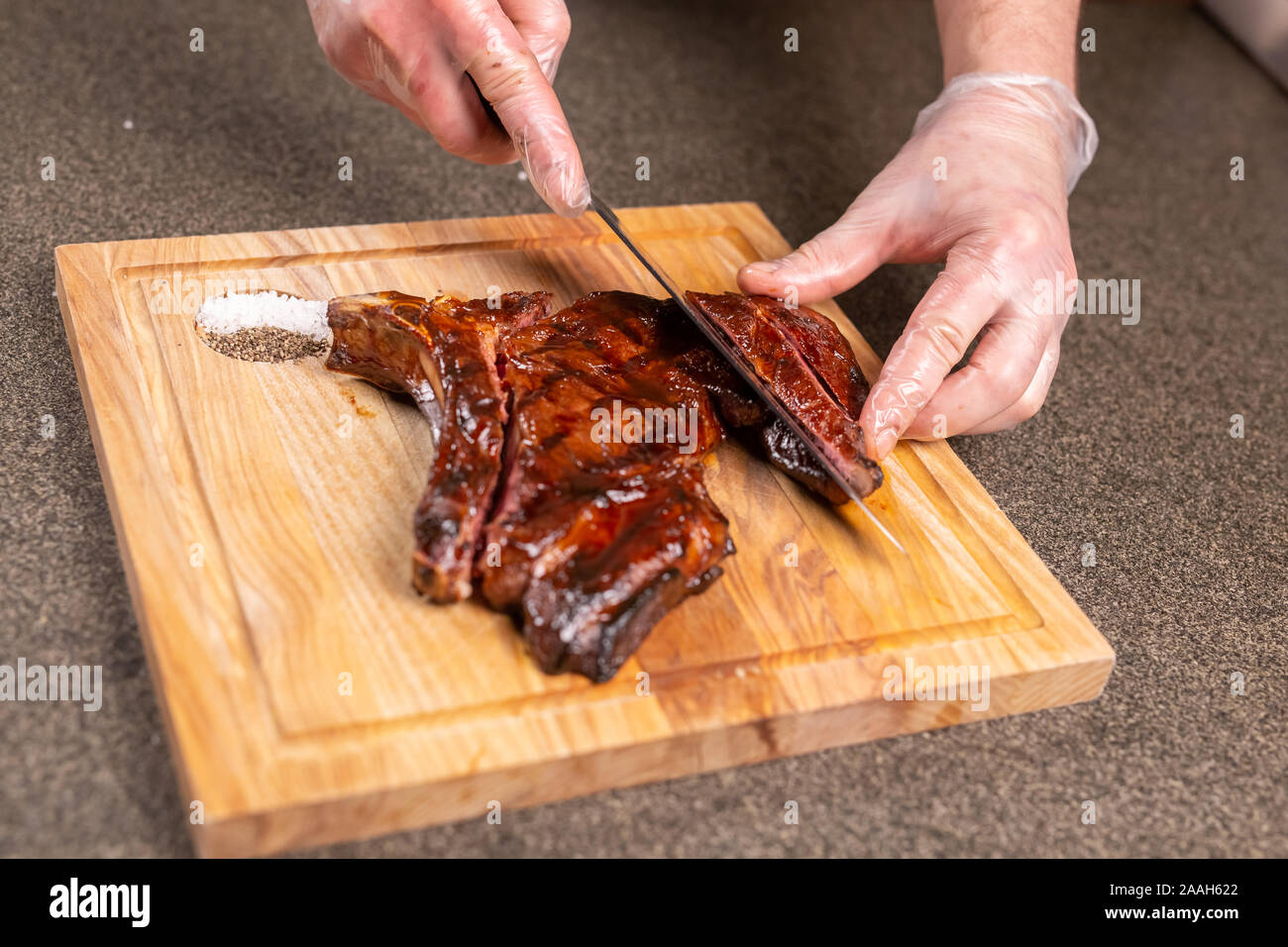 food, delicious and craft concept - Man cutting horse steak Stock Photo ...