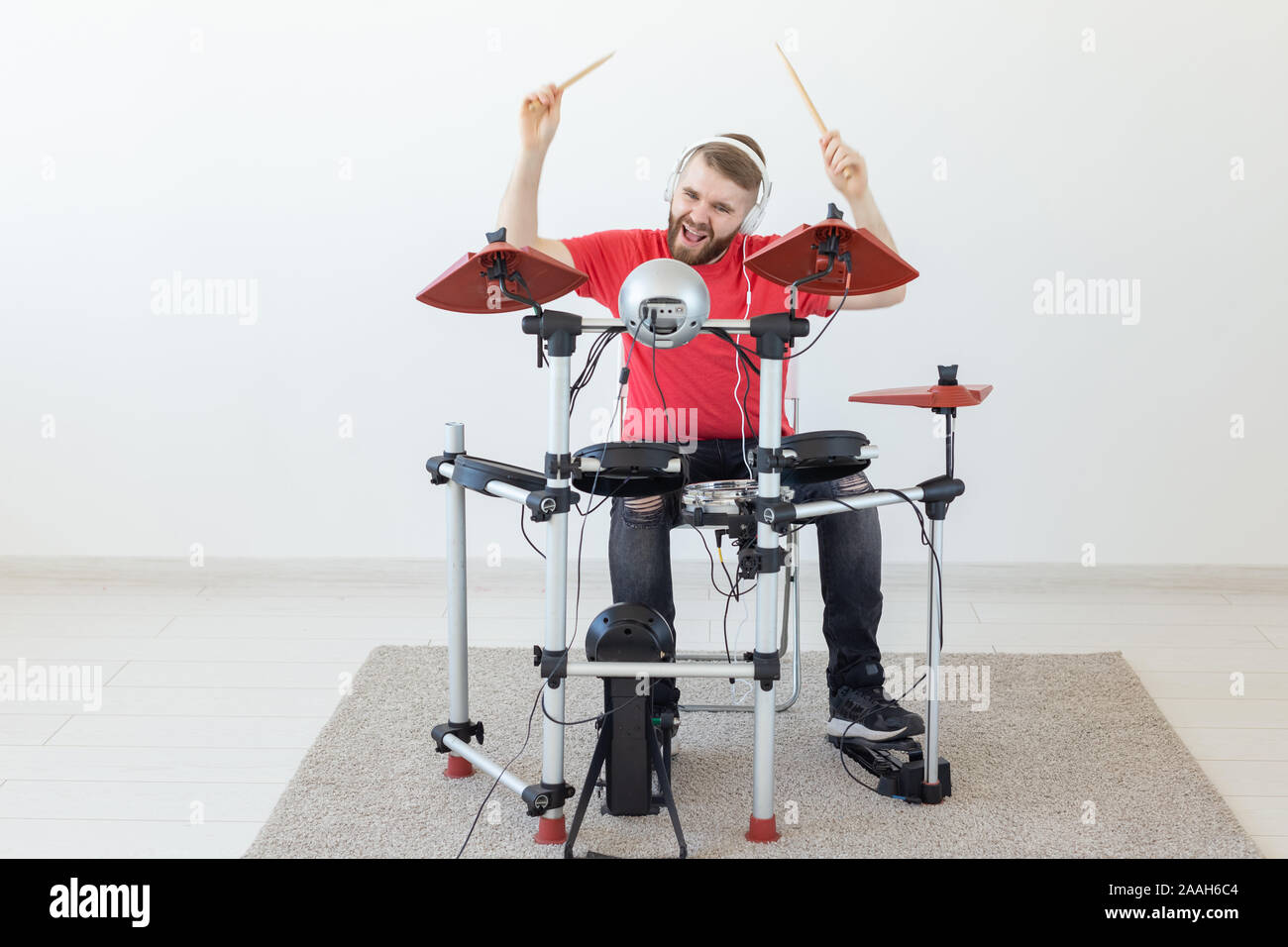 People, music and hobby concept - Man dressed in red t-shirt playing on ...