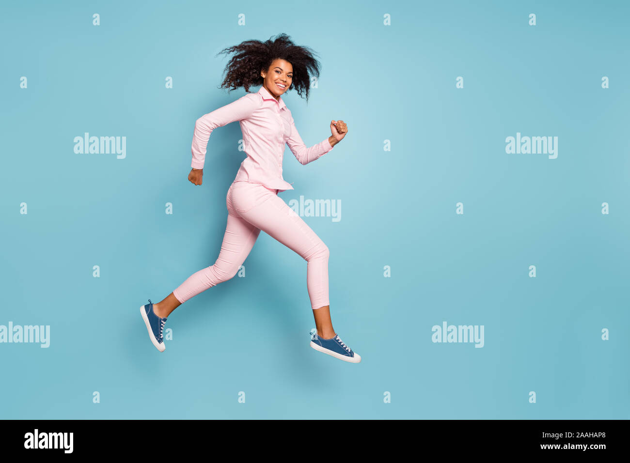 Full length photo of amazing dark skin wavy lady jumping high speed ...