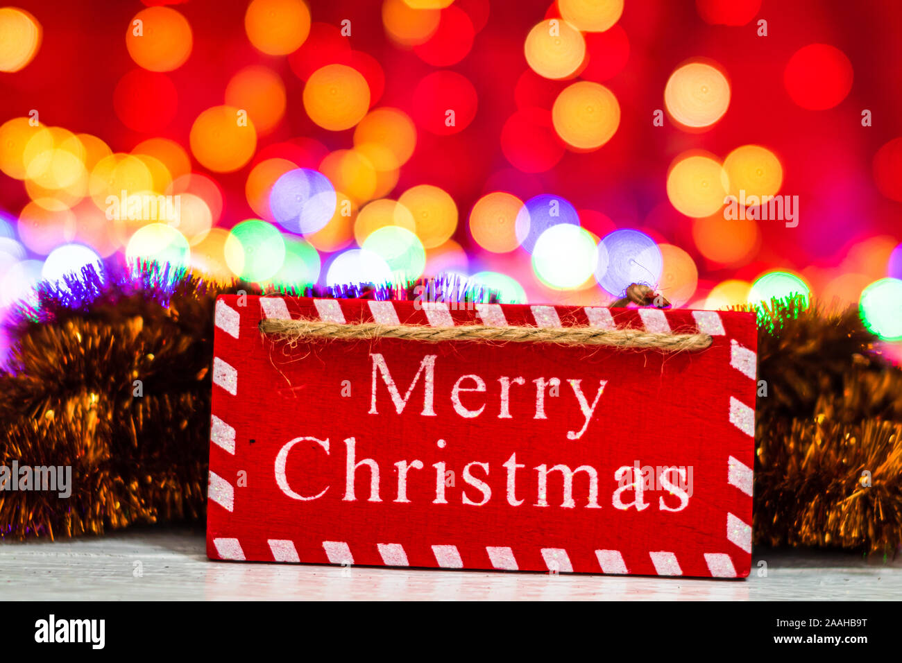 Merry Christmas wooden sign. Christmas composition on blurred lights ...