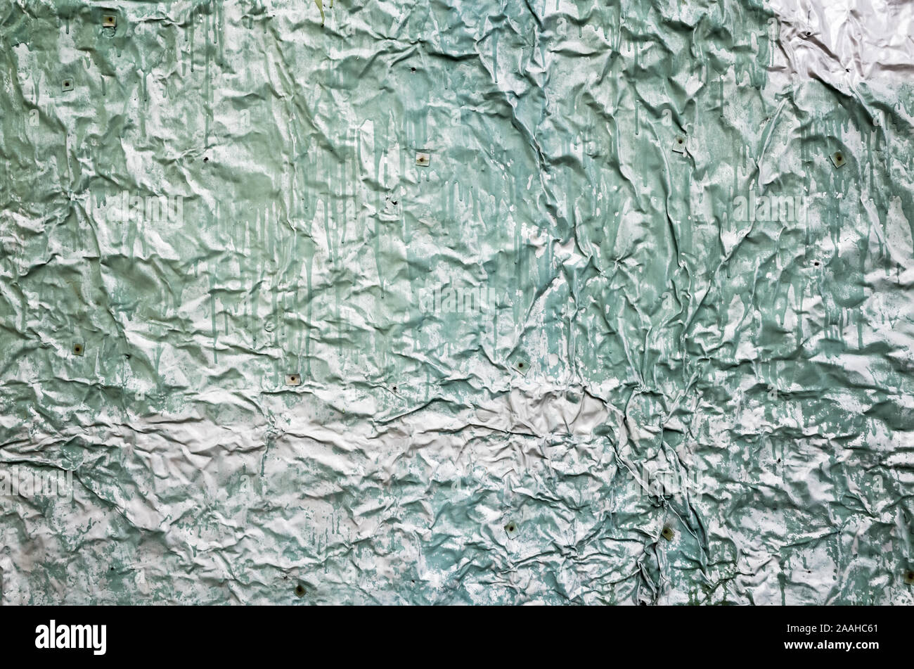 Crumpled metal surface with damaged green paint layer, background photo ...