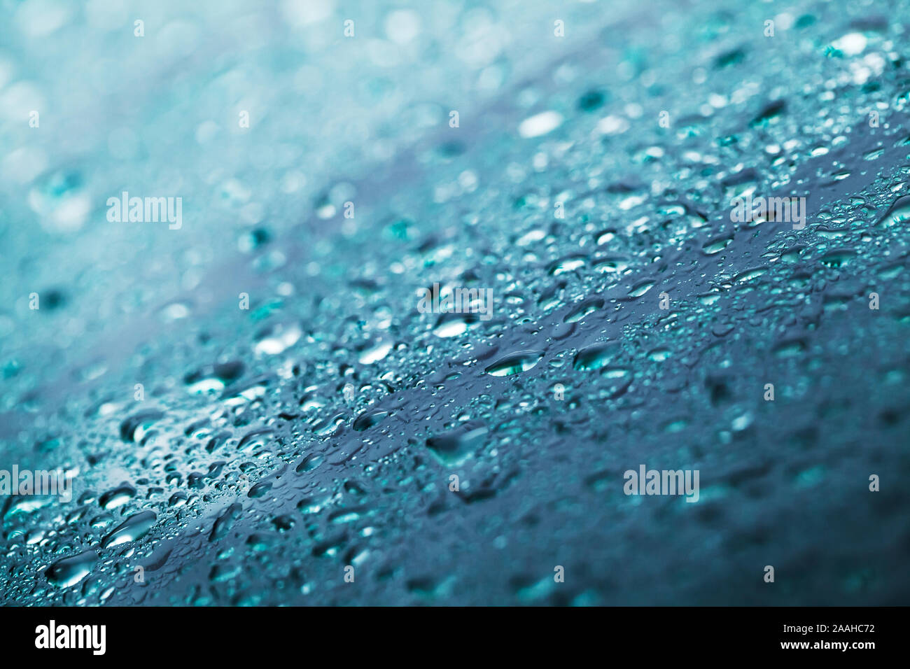 Blue wet windshield, glass surface with droplets, photo background with ...