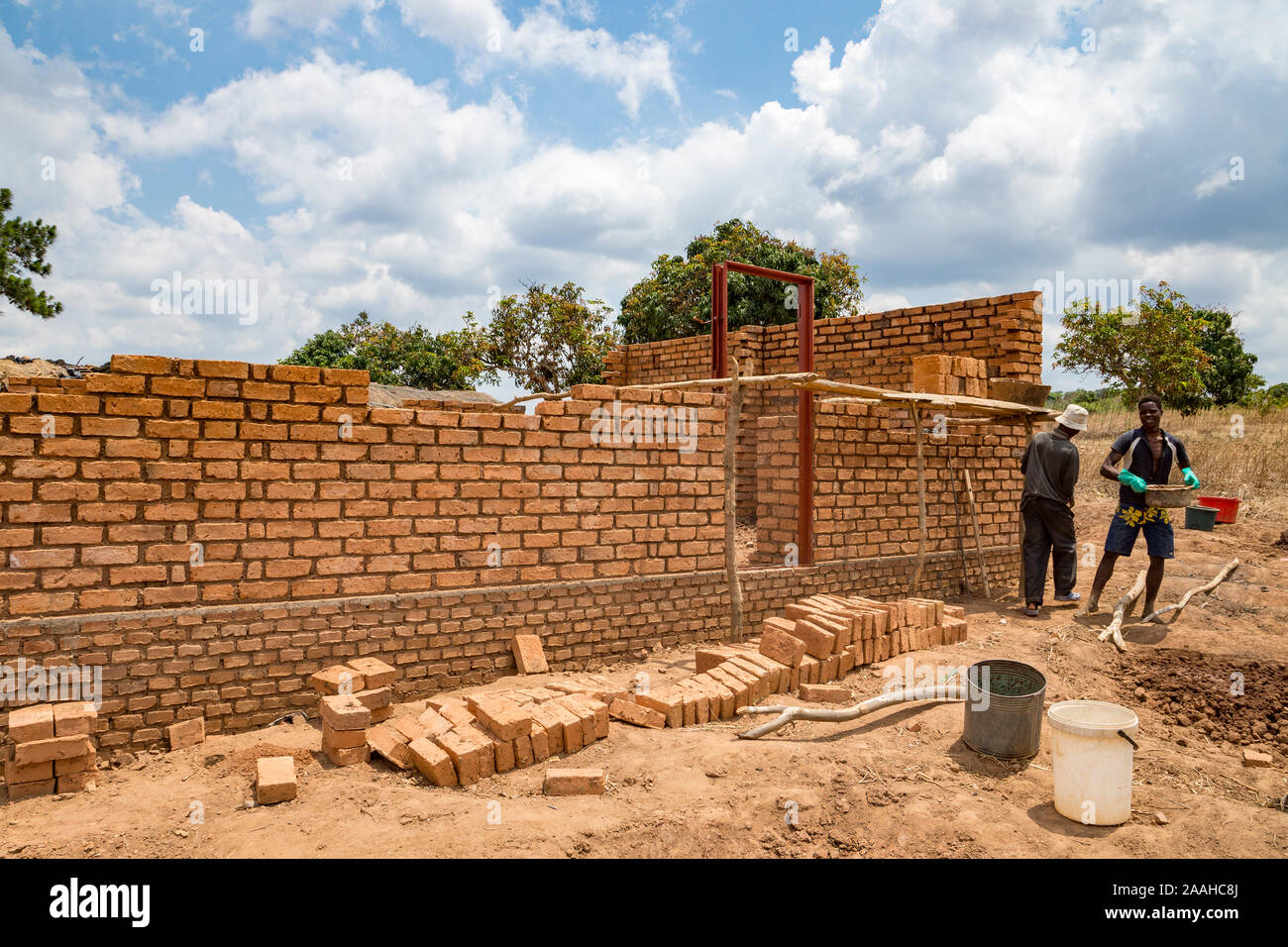 Two men build a house using bricks in a remote part of northern Malawi ...