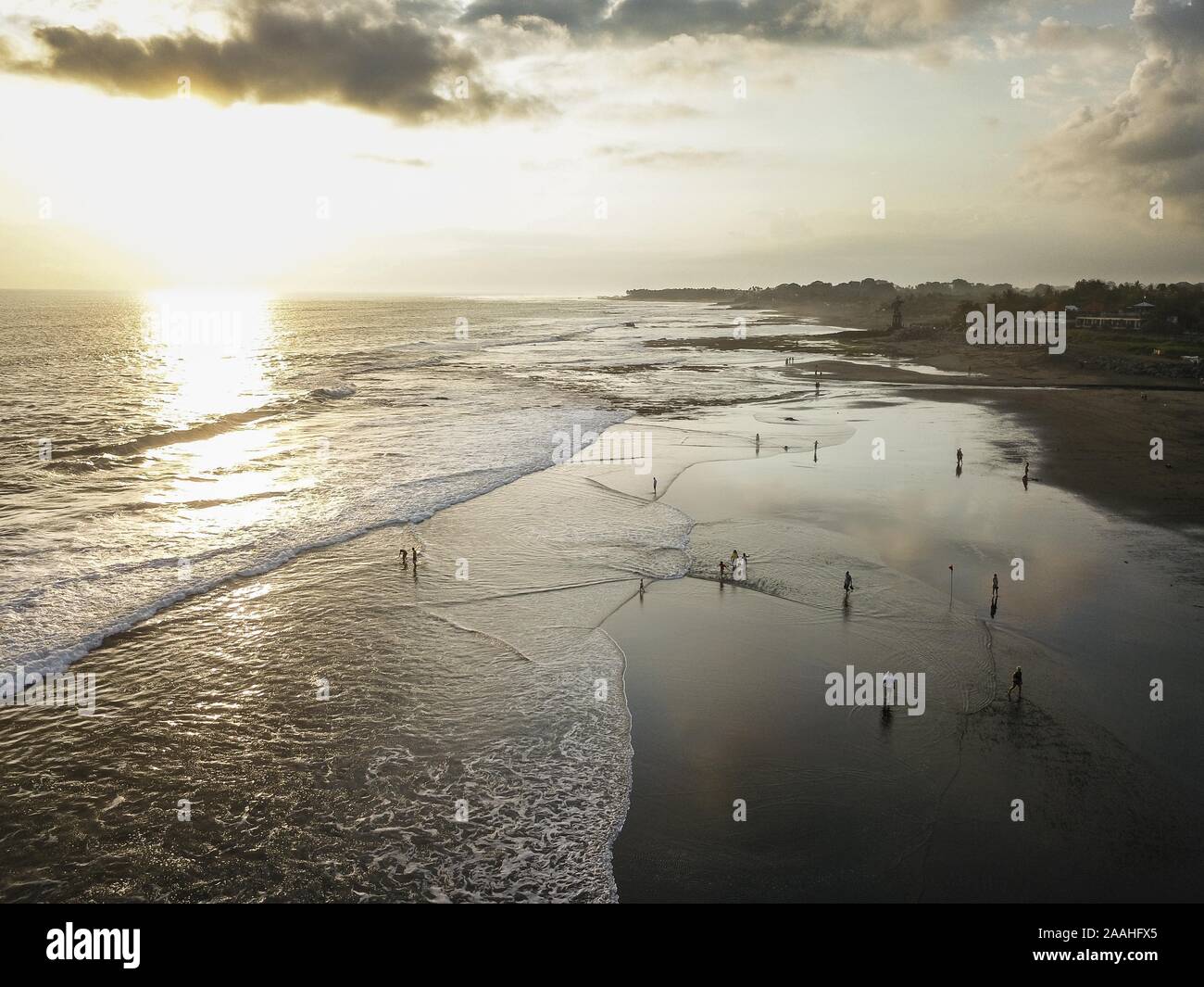 Black volcanic beach with waves running out in the sunset hi-res stock ...