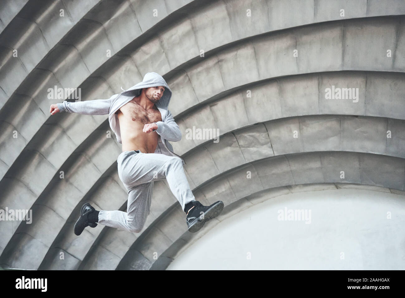 Man engaged in parkour jumping on the street workout Stock Photo - Alamy