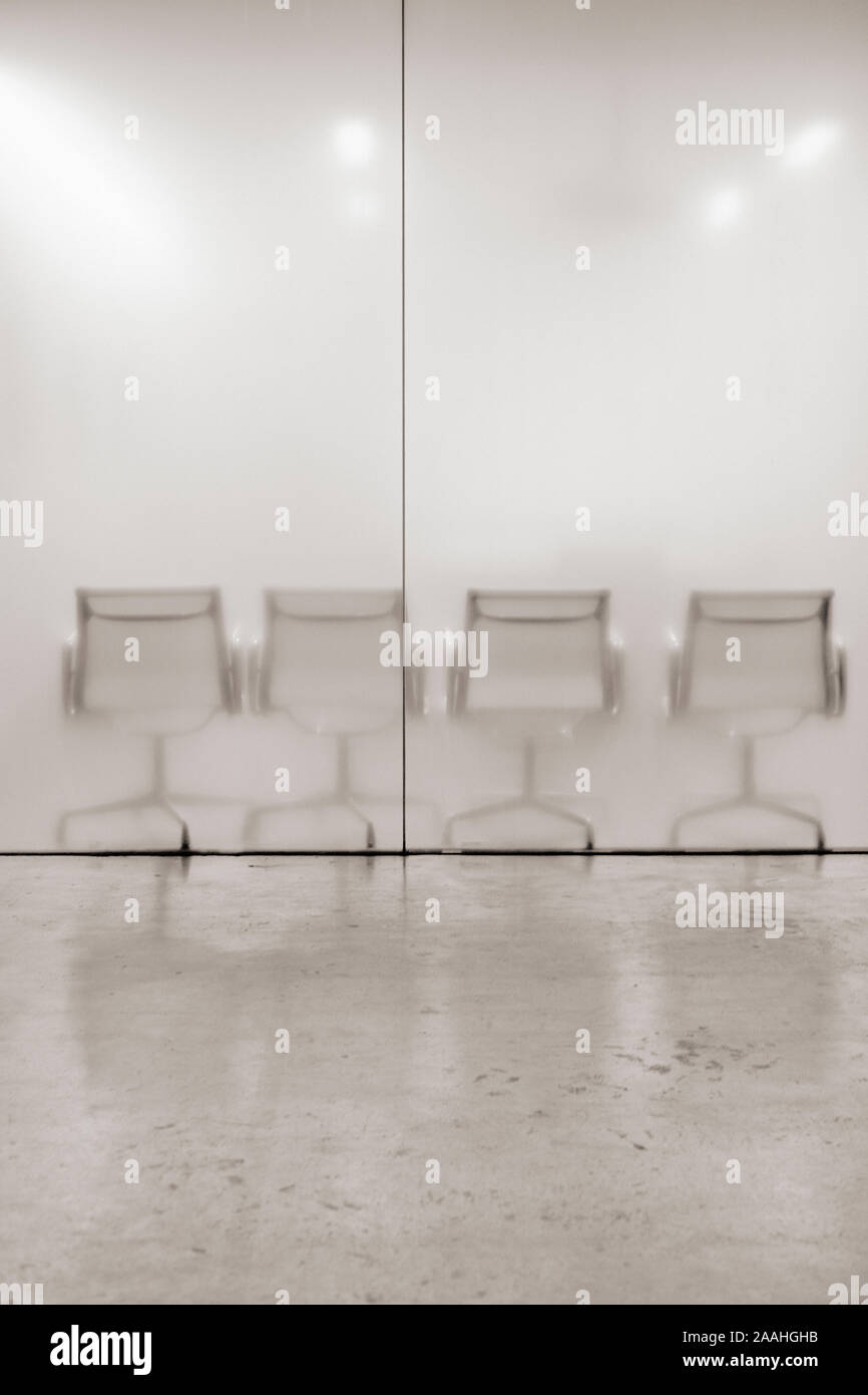 Empty chairs behind a glass office wall partition - waiting room ...