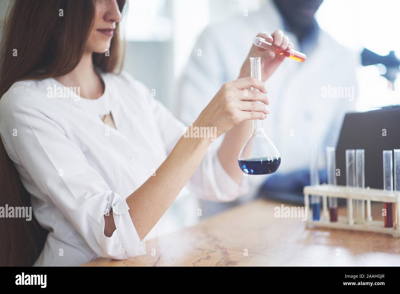 Scientists work closely with the microscope in the laboratory by ...