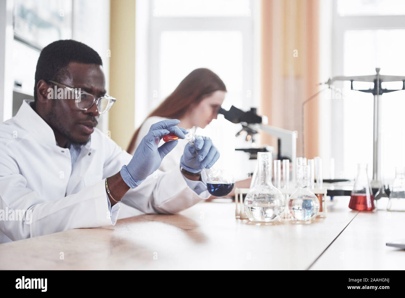Scientists work closely with the microscope in the laboratory by conducting experiments and ...
