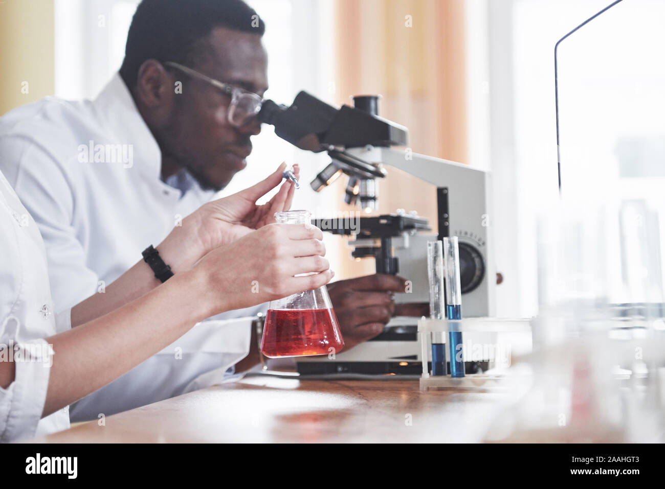Scientists work closely with the microscope in the laboratory by ...