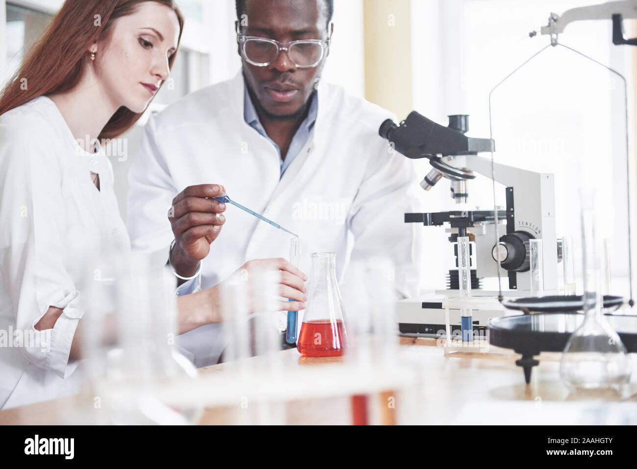 Scientists work closely with the microscope in the laboratory by ...